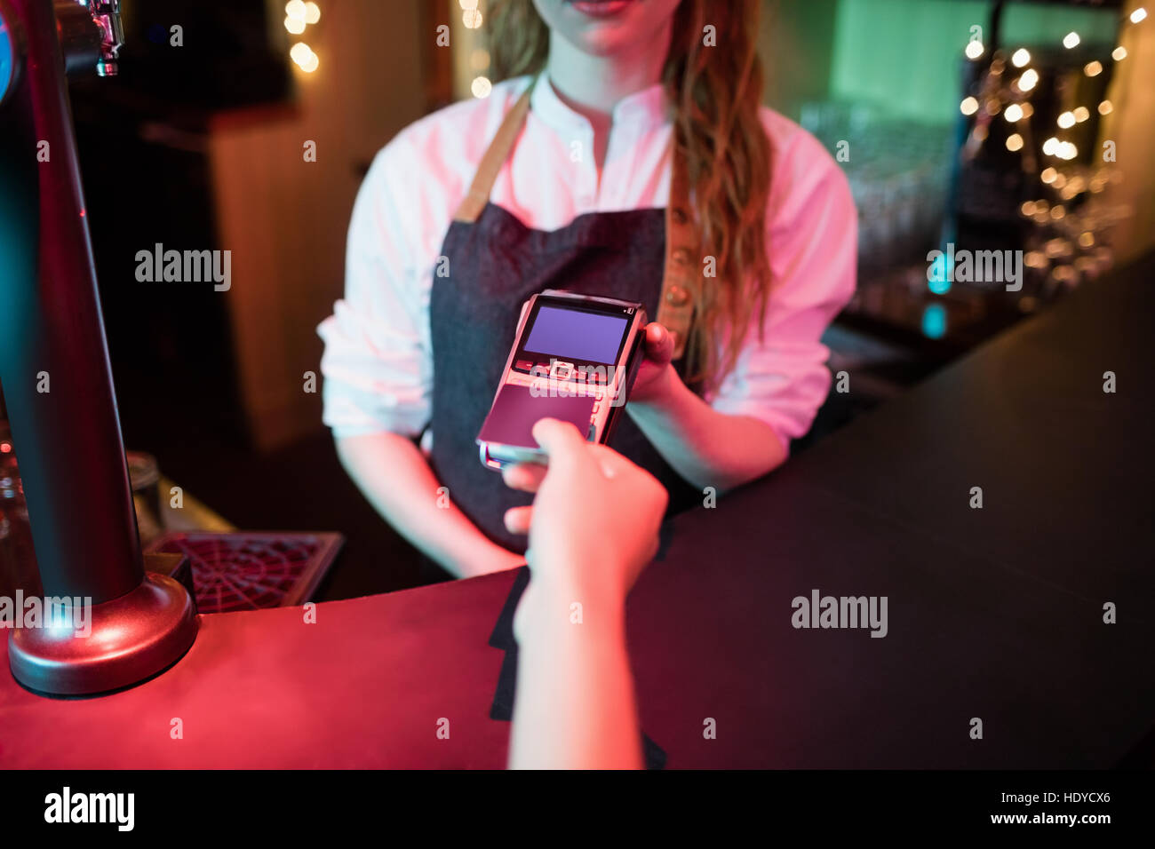 Customer making payment through credit card at counter in bar Stock ...