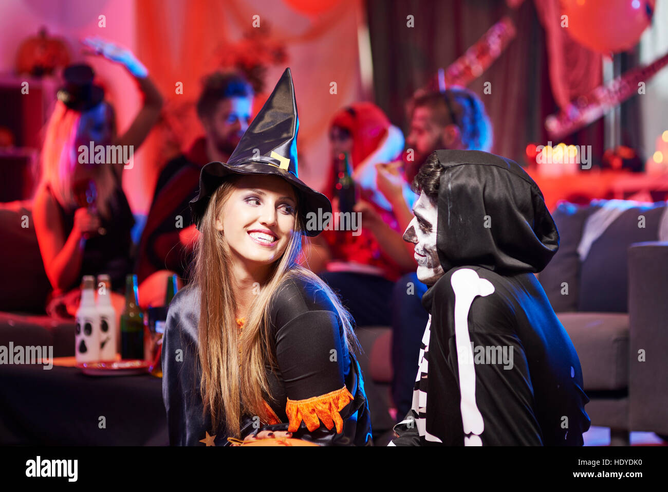 Flirty situation between witch and skeleton Stock Photo - Alamy
