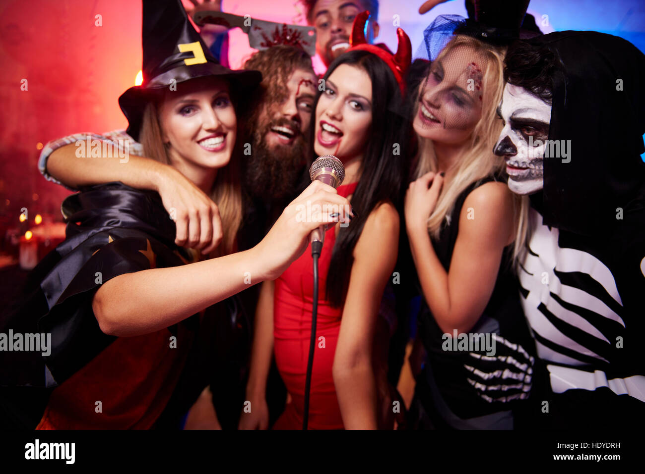 Group of friends singing at the party Stock Photo - Alamy
