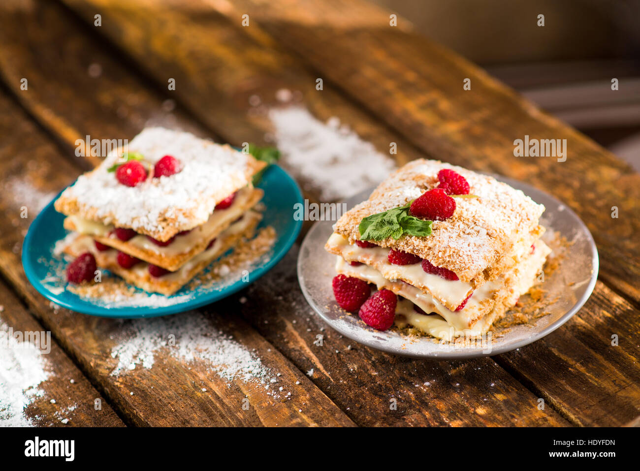 Mille-feuille of puff pastry with raspberries on a wooden Board Stock ...