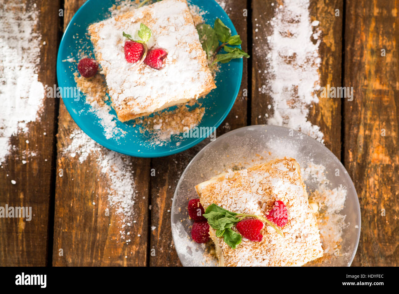 Mille-feuille of puff pastry with raspberries on a wooden Board Stock ...