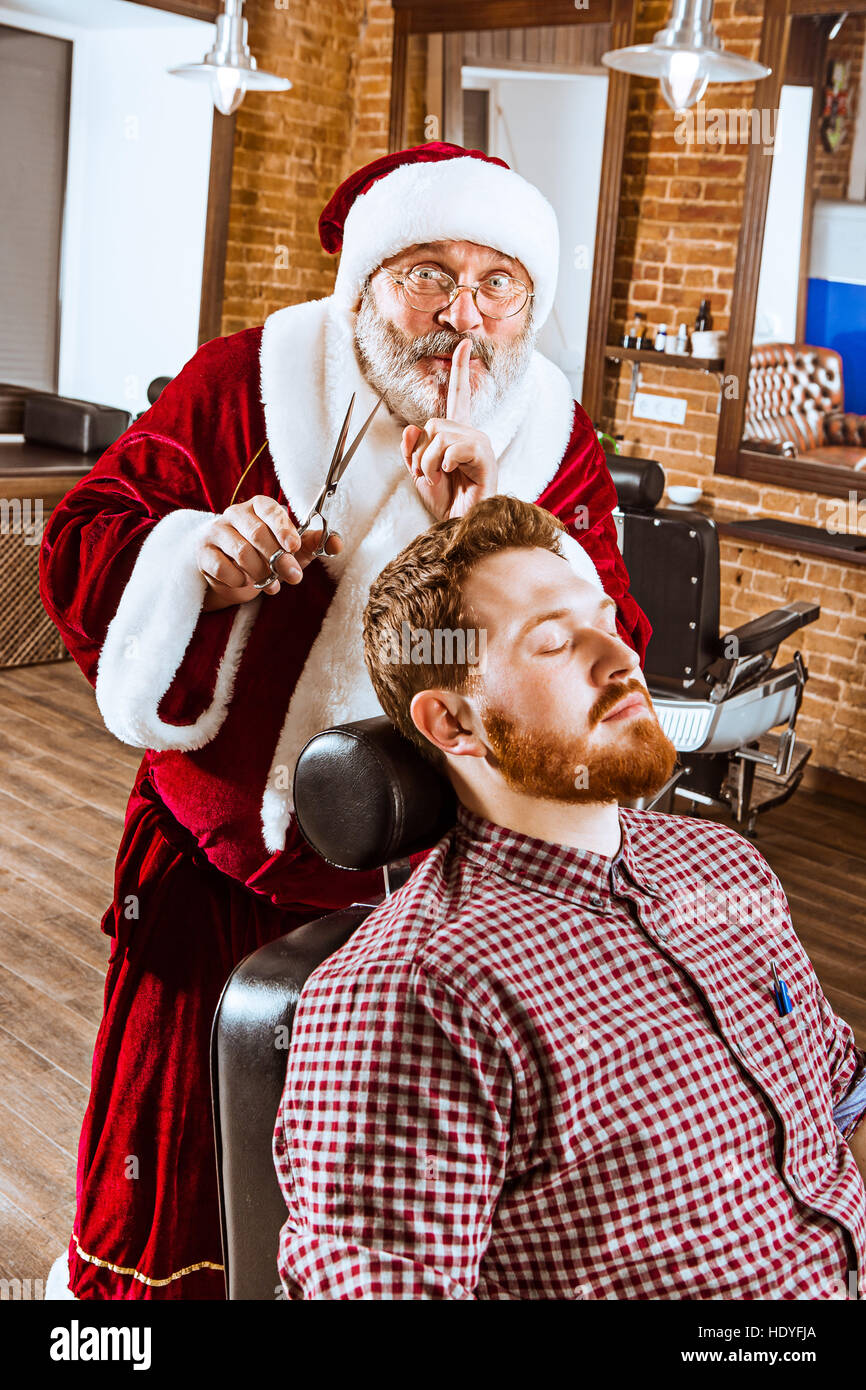 Santa claus as master at barber shop Stock Photo - Alamy
