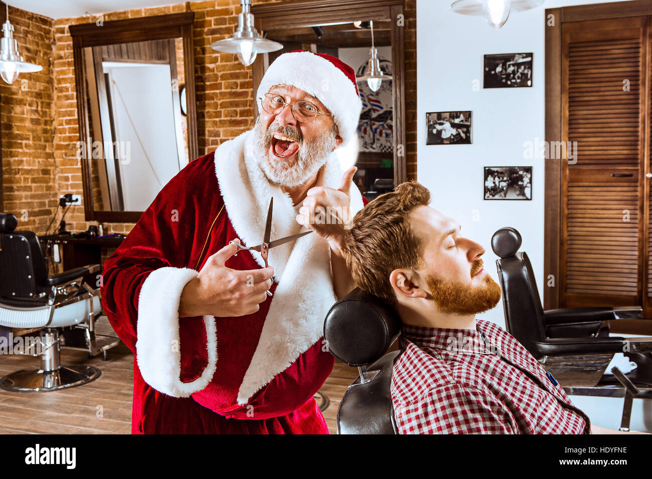 Santa claus as master at barber shop Stock Photo - Alamy