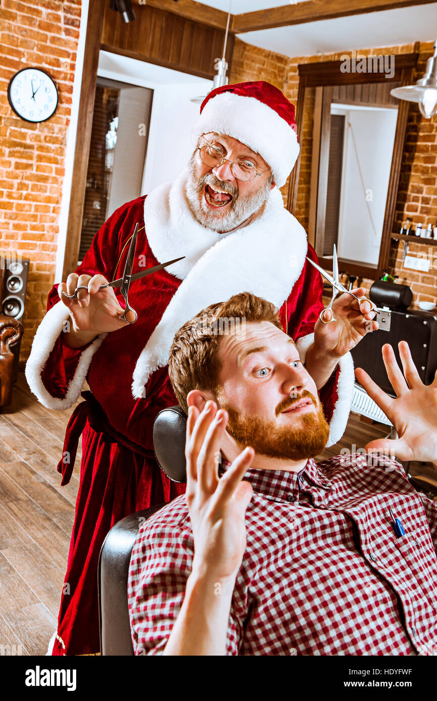 Santa claus as master at barber shop Stock Photo - Alamy