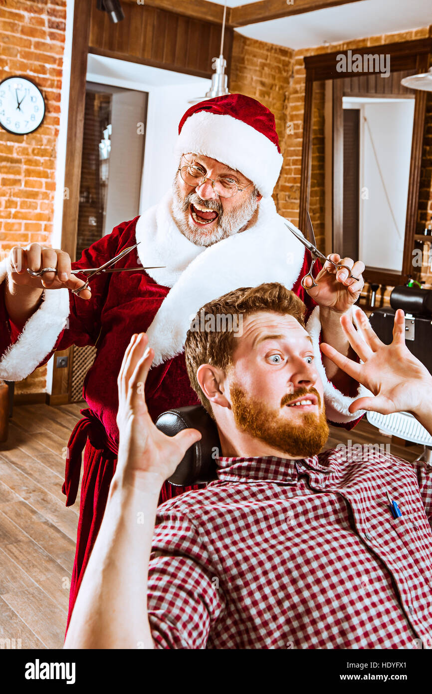 Santa claus as master at barber shop Stock Photo - Alamy