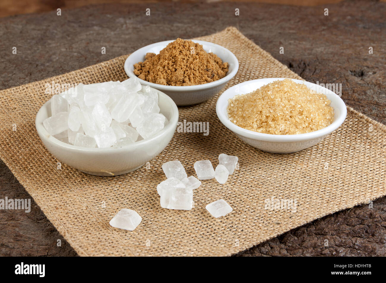 Brown cane sugar and granulated sugar and rock sugar in a cup on old ...
