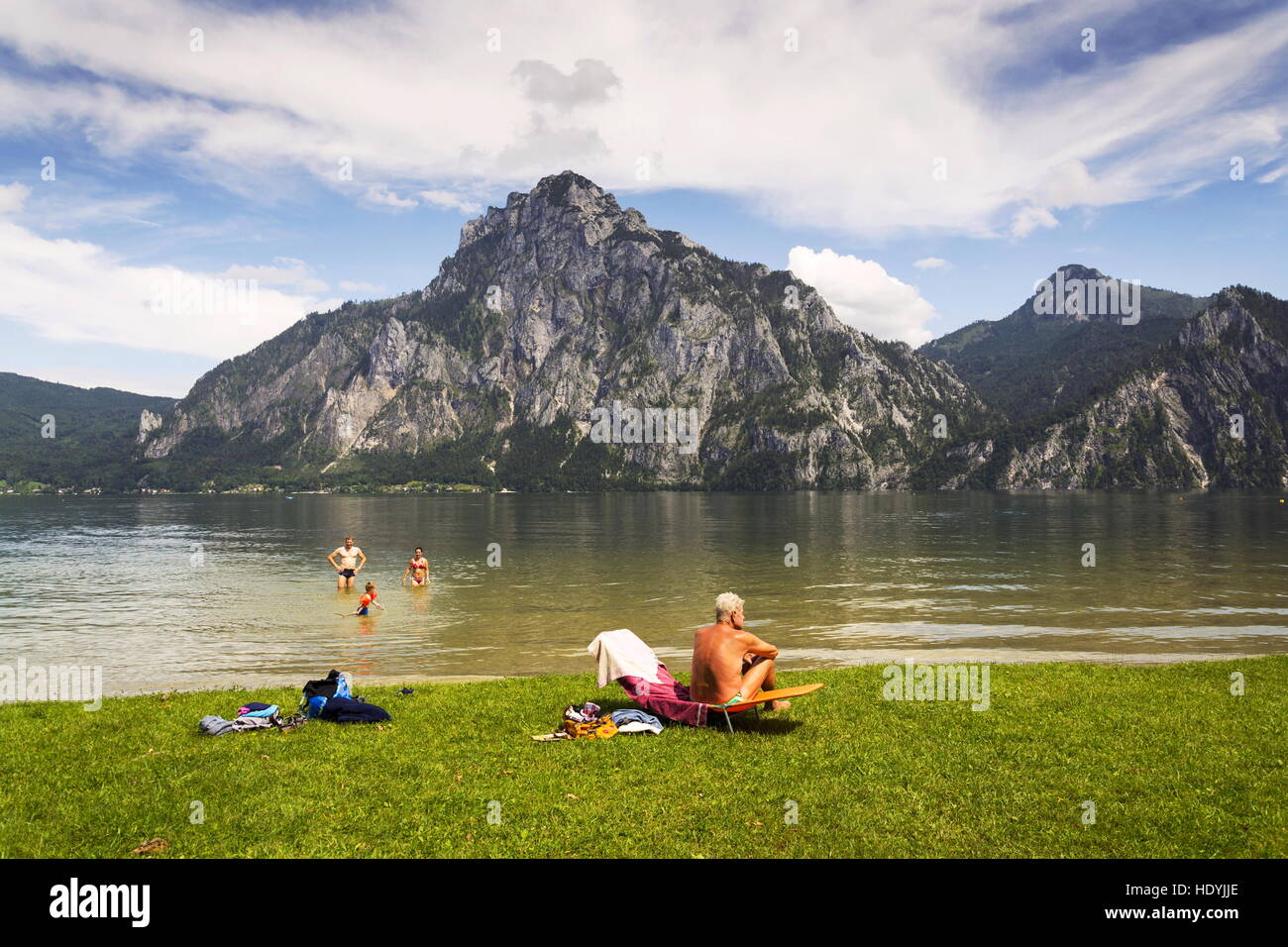 TRAUNKIRCHEN, AUSTRIA - JULY 24: Tourist bath in Traunsee with ...