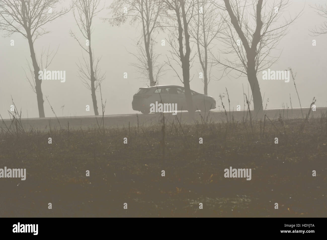 Vehicles drive in fog Stock Photo - Alamy