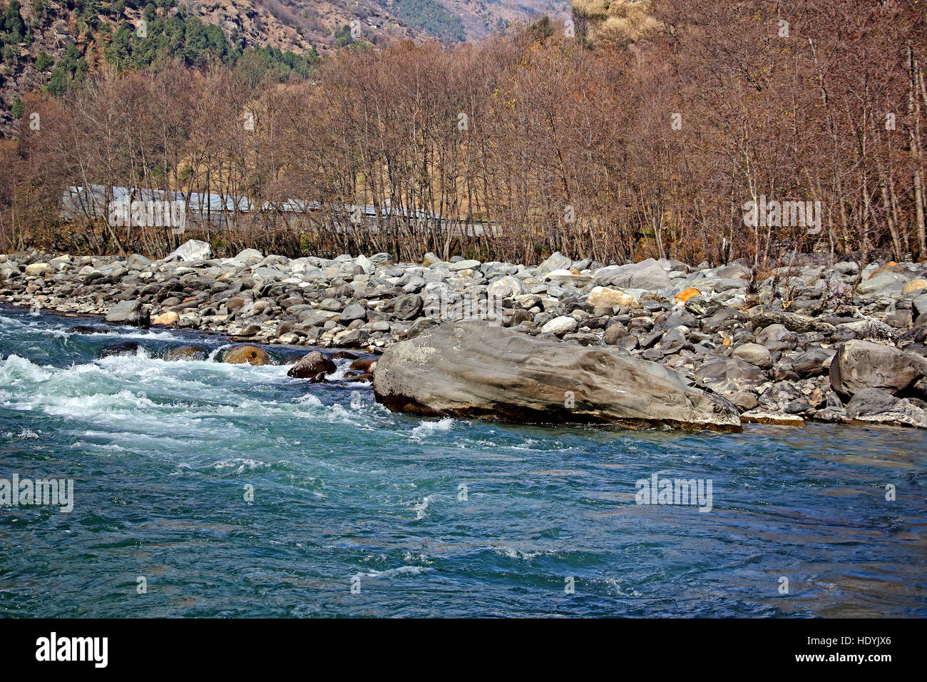 Beas river forming rapids while flowing through granite boulders at the ...