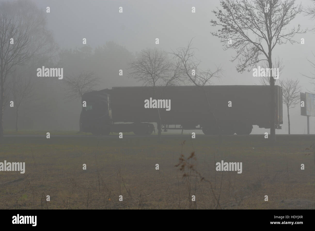 Vehicles drive in fog Stock Photo - Alamy