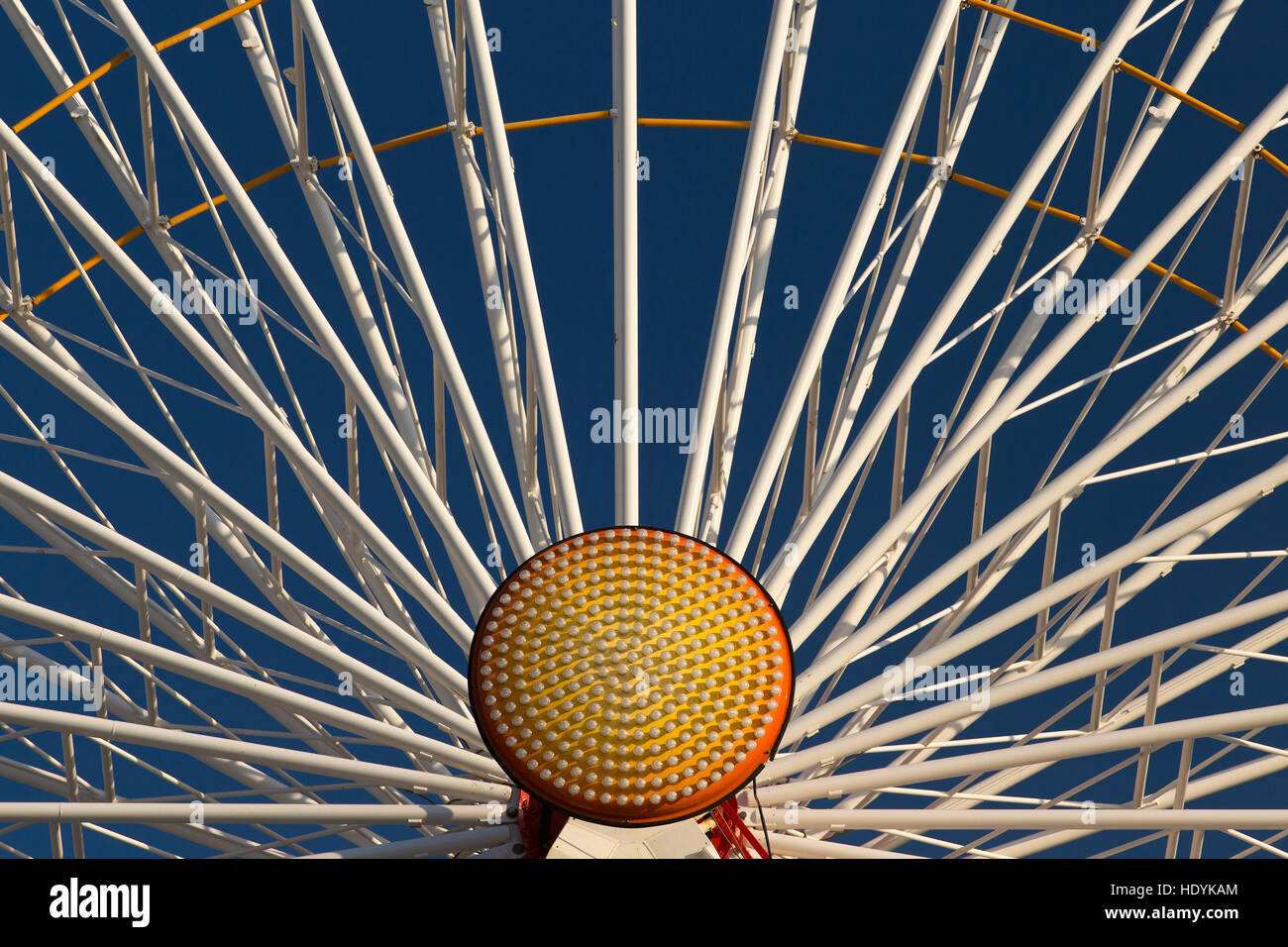 Close up of centre of giant Ferris Wheel at fun fair against a clear ...