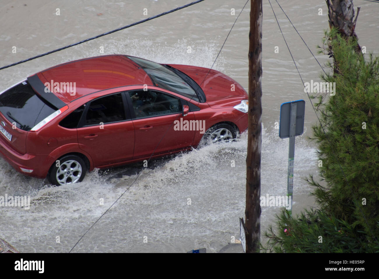 Vehicles drive through floodwater and flooded streets after a flash ...