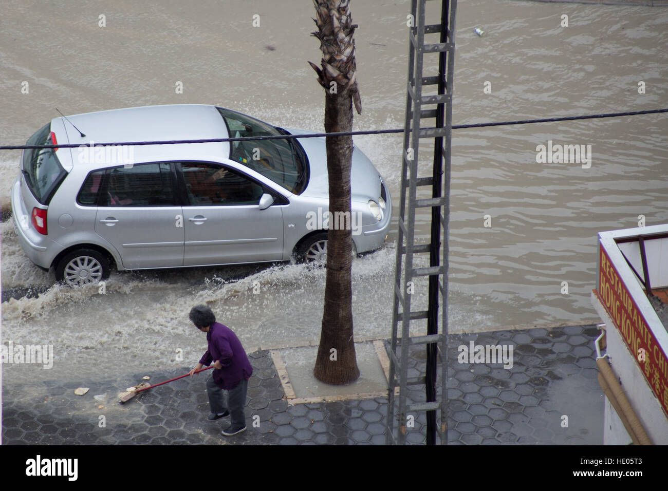 Vehicles drive through floodwater and flooded streets after a flash ...