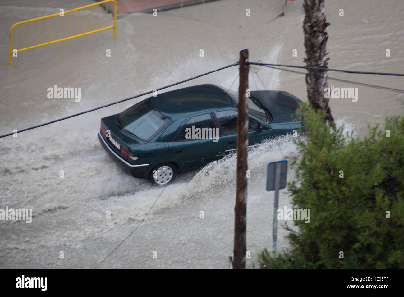 Vehicles drive through floodwater and flooded streets after a flash ...