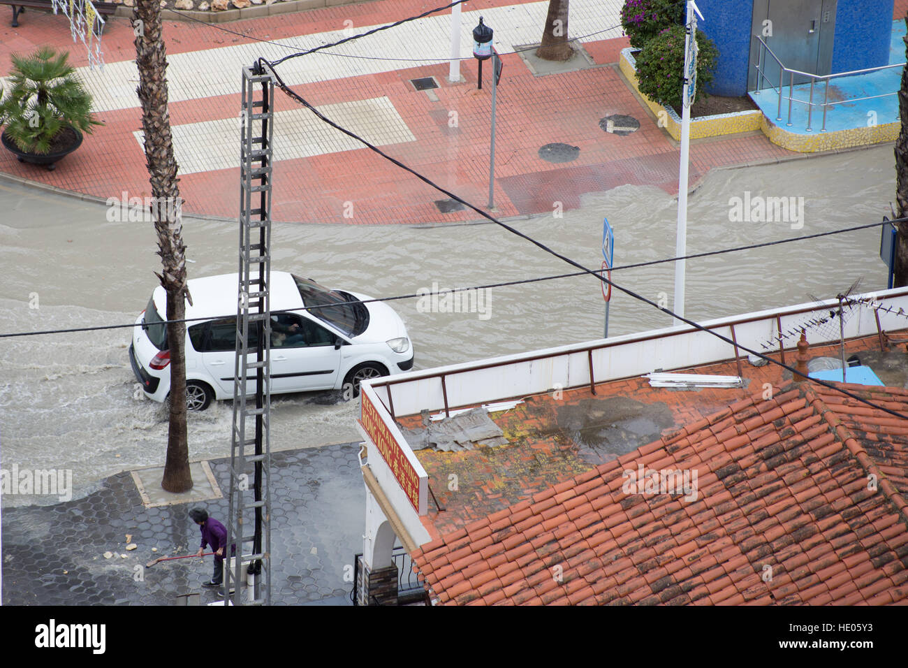Vehicles drive through floodwater and flooded streets after a flash ...