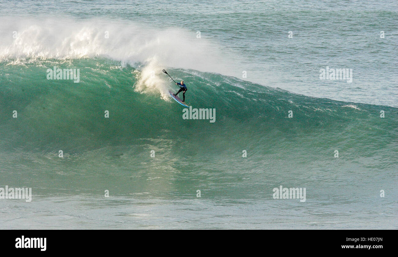 Newquay, UK. 16th December 2016. Asurfer riding the Cribbar. This is ...