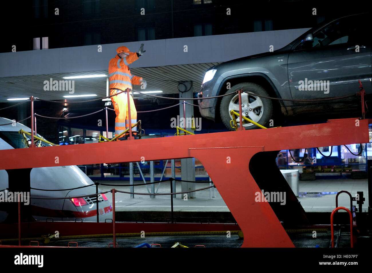 Hamburg, Germany. 16th Dec, 2016. A worker directs a car onto a ...