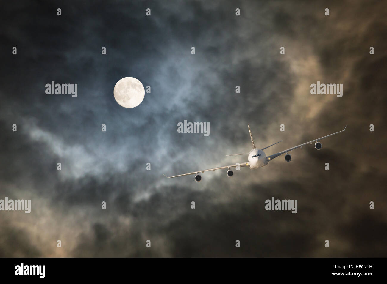 Passenger jet airliner makes non-stop night flight in the light of full ...