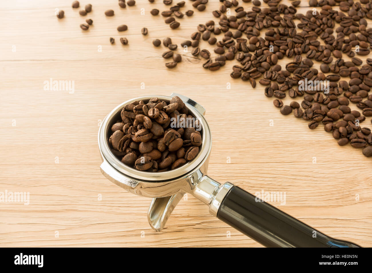 Closeup of a Portafilter filled with Coffee beans Stock Photo - Alamy
