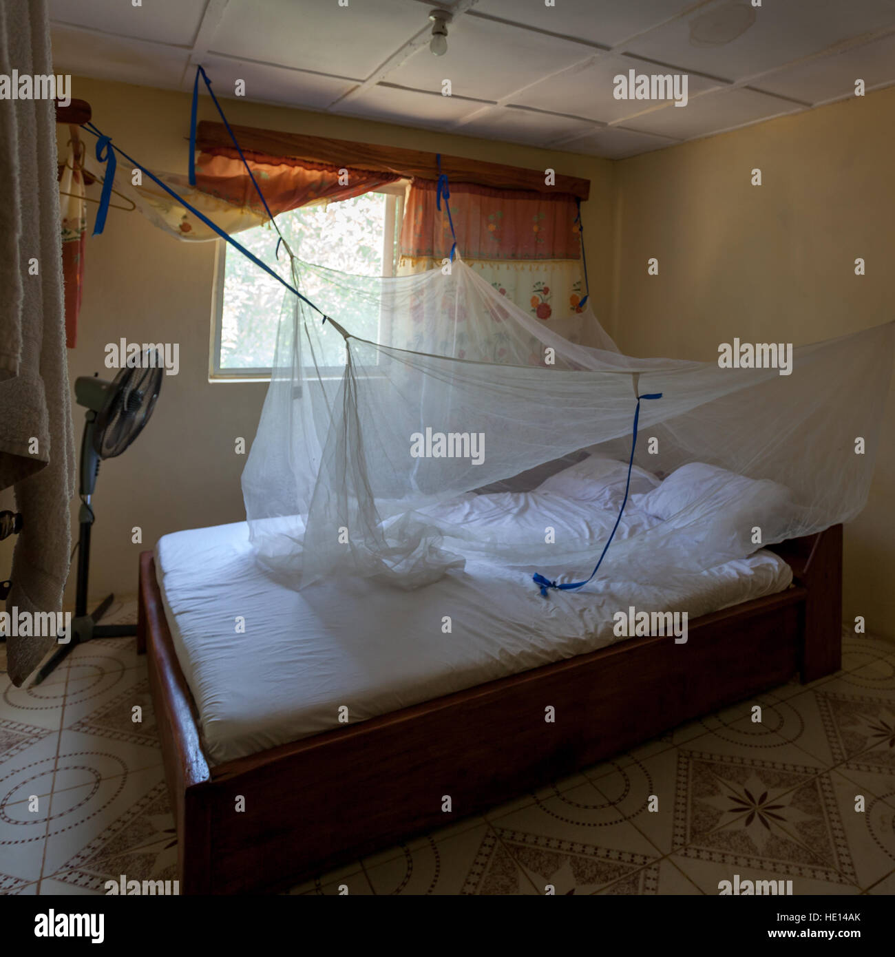 Bedroom with mosquito net in Sierra Leone Stock Photo - Alamy