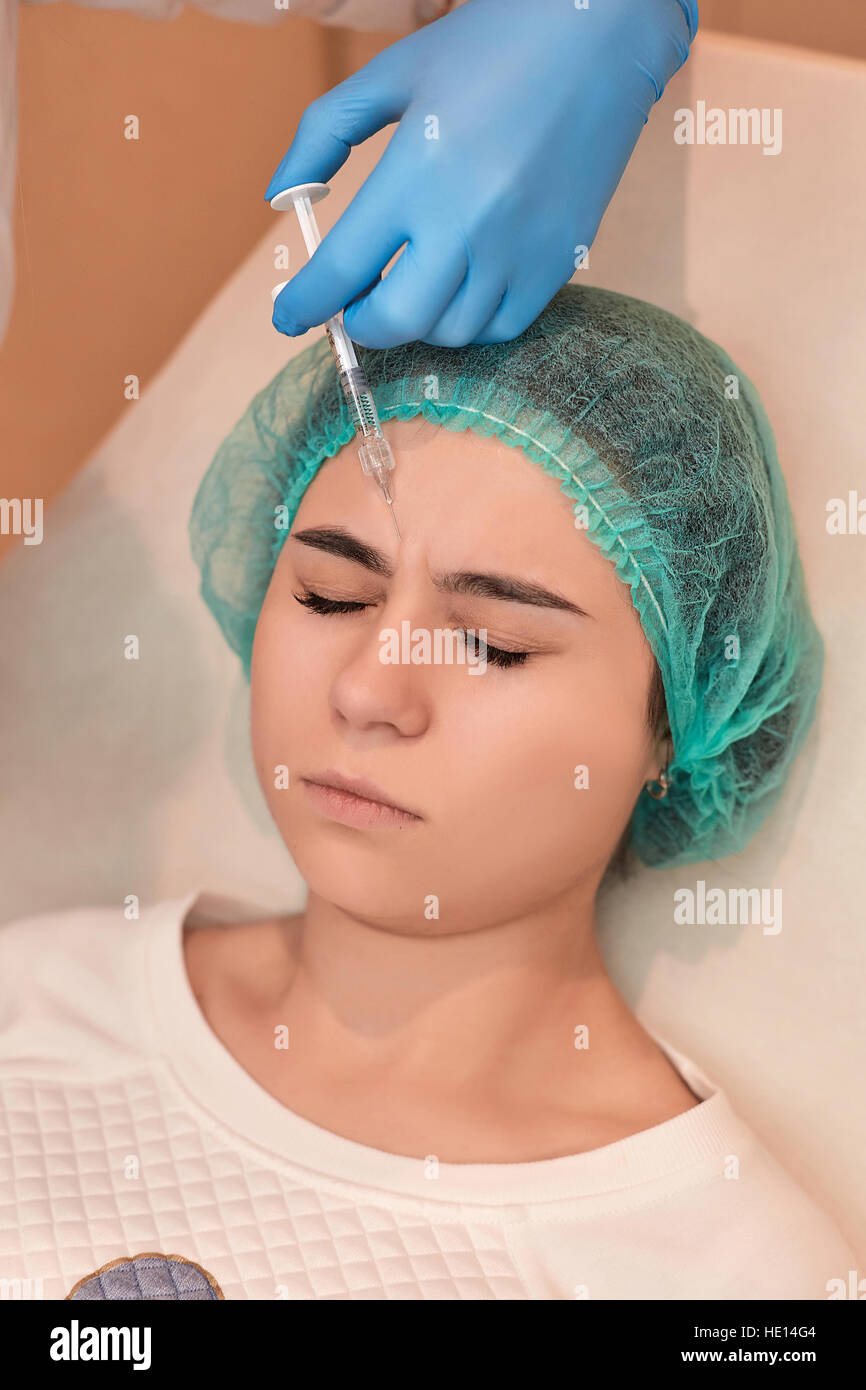 Beautiful young woman is caring of her skin at beautician office Stock ...