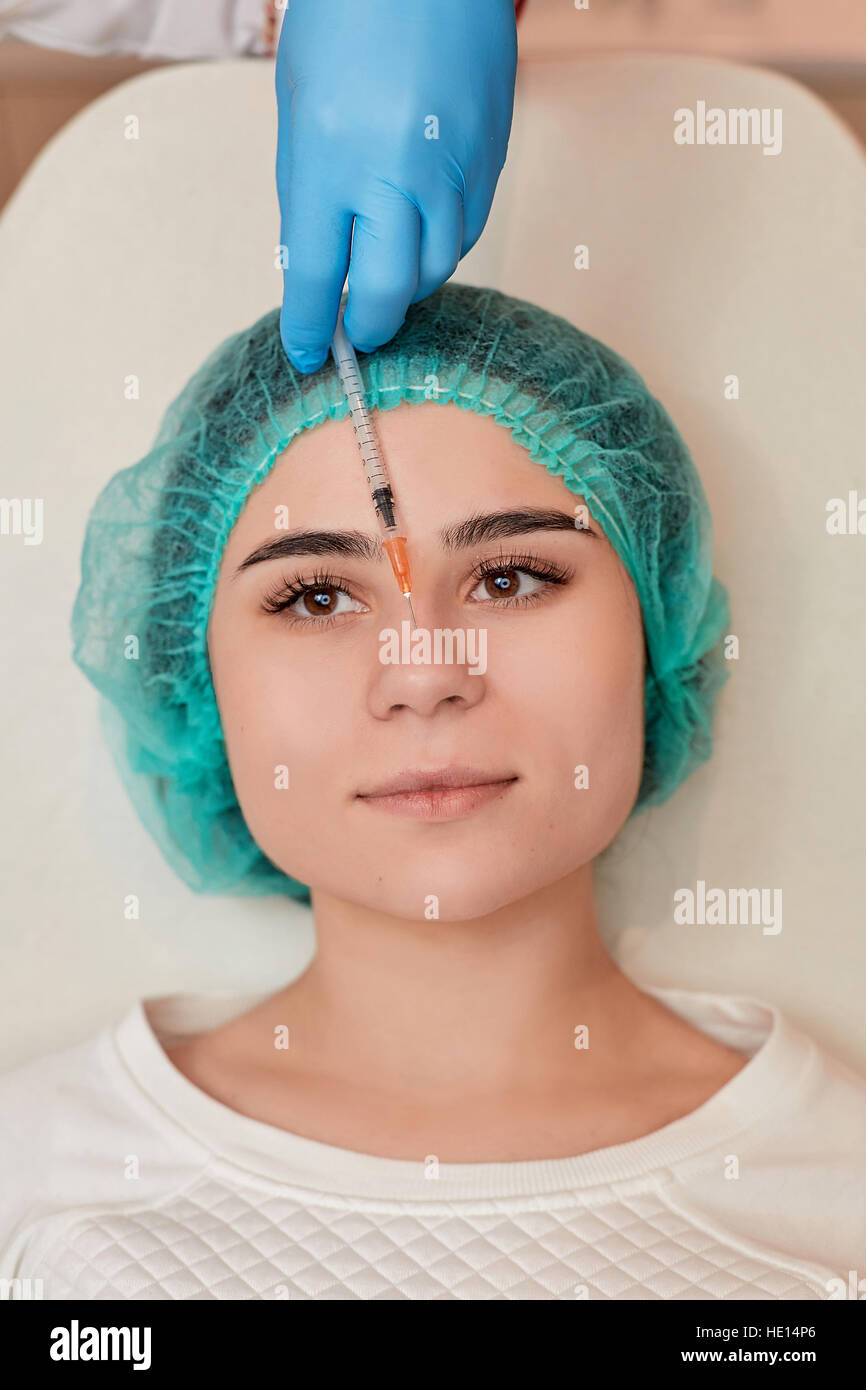 Woman receiving cosmetic injection through nose Stock Photo - Alamy