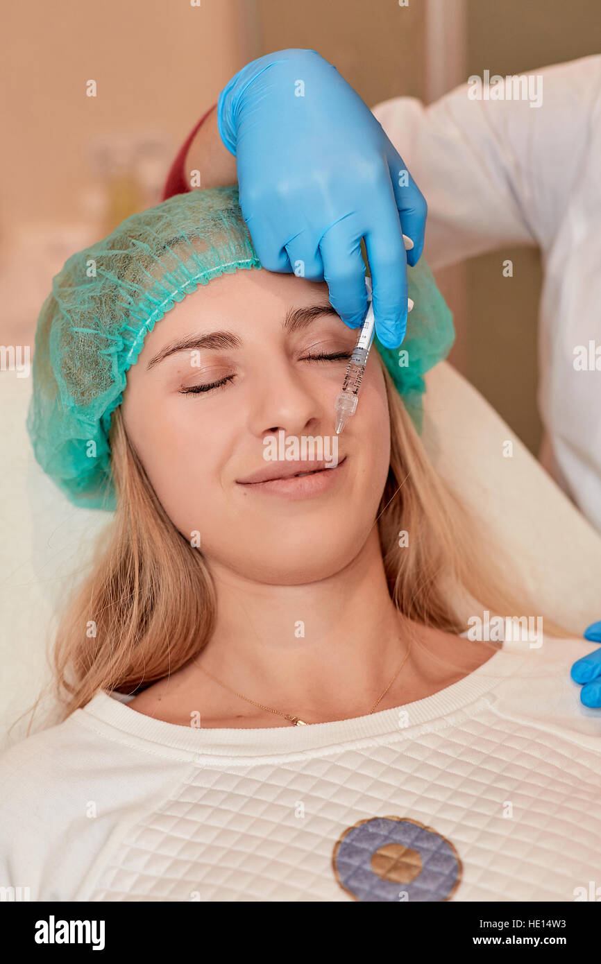 Beautiful young woman is caring of her skin at beautician office Stock ...