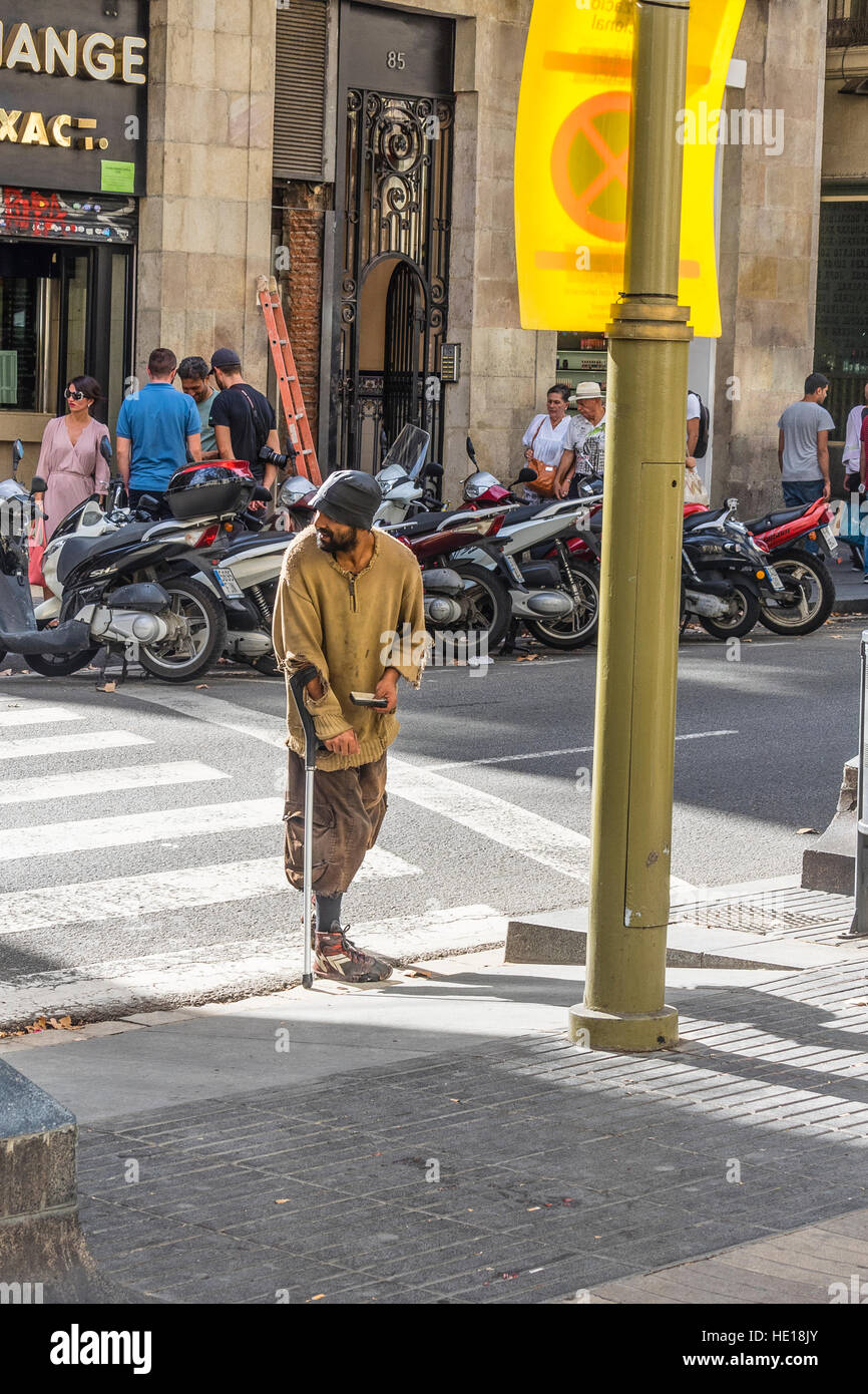 A disabled Spanish poor man wearing tattered clothing and using a brace ...
