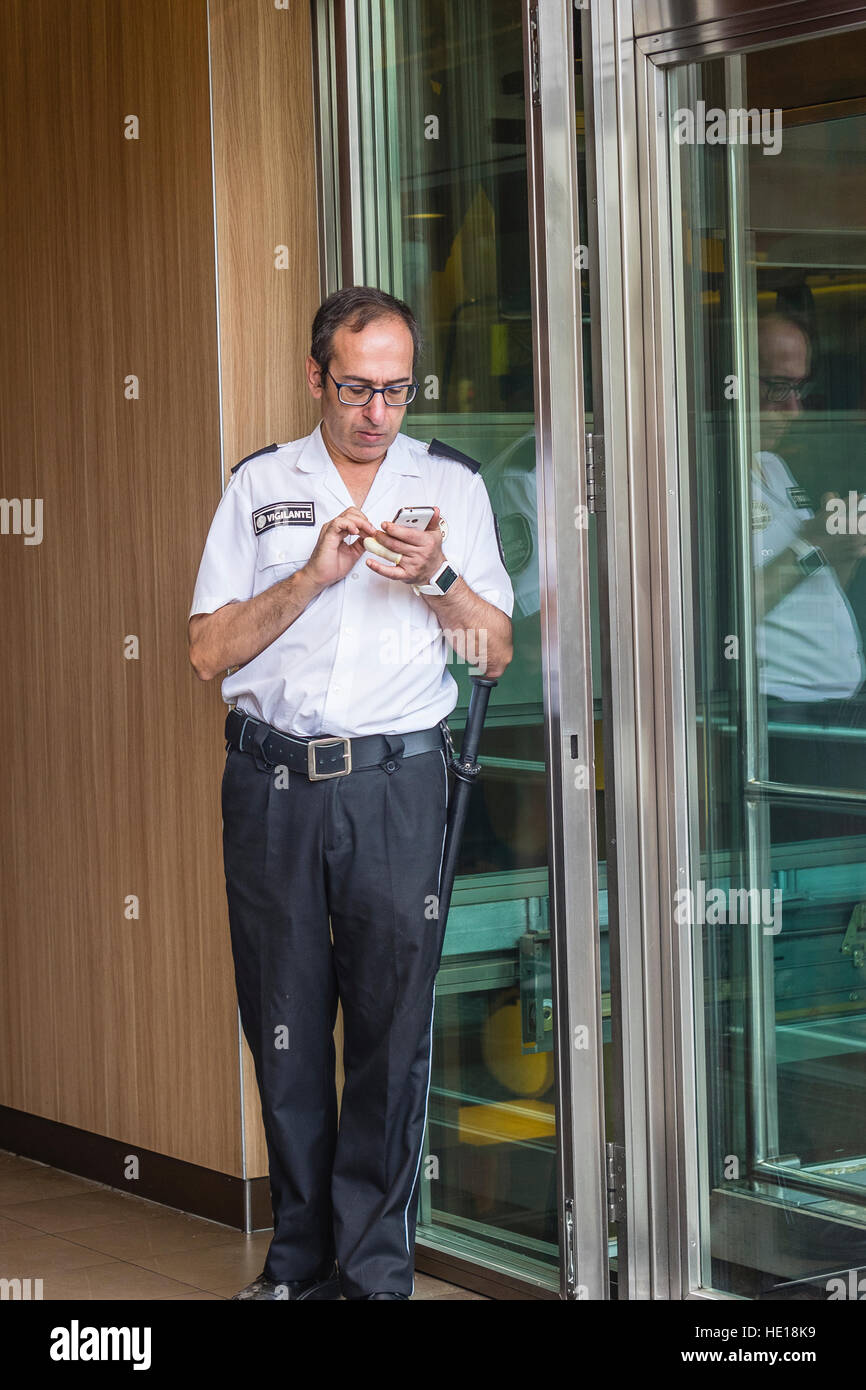 High tech private security guard checking hi-res stock photography and ...