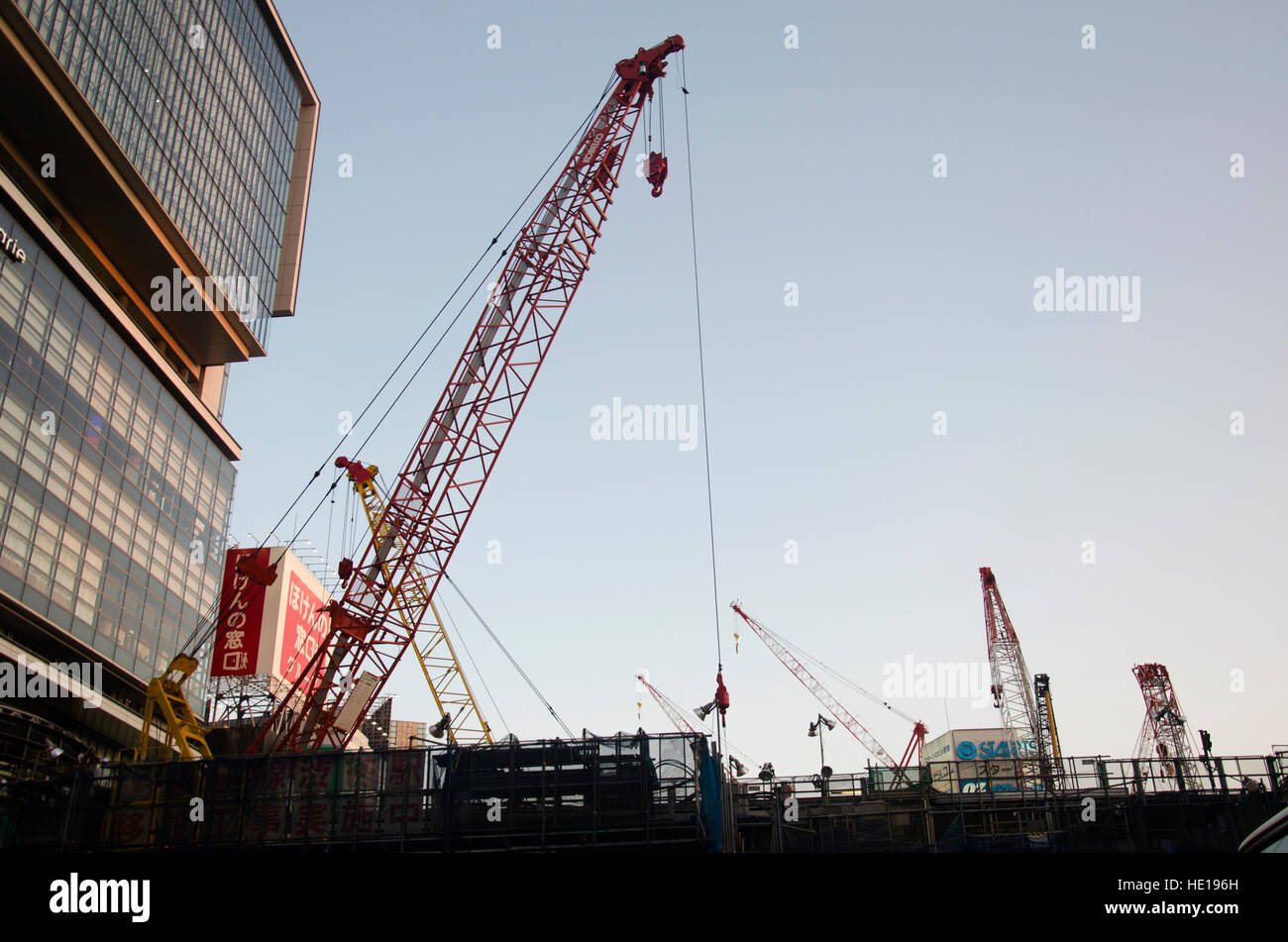 Japanese people and machinery working in construction site build town ...