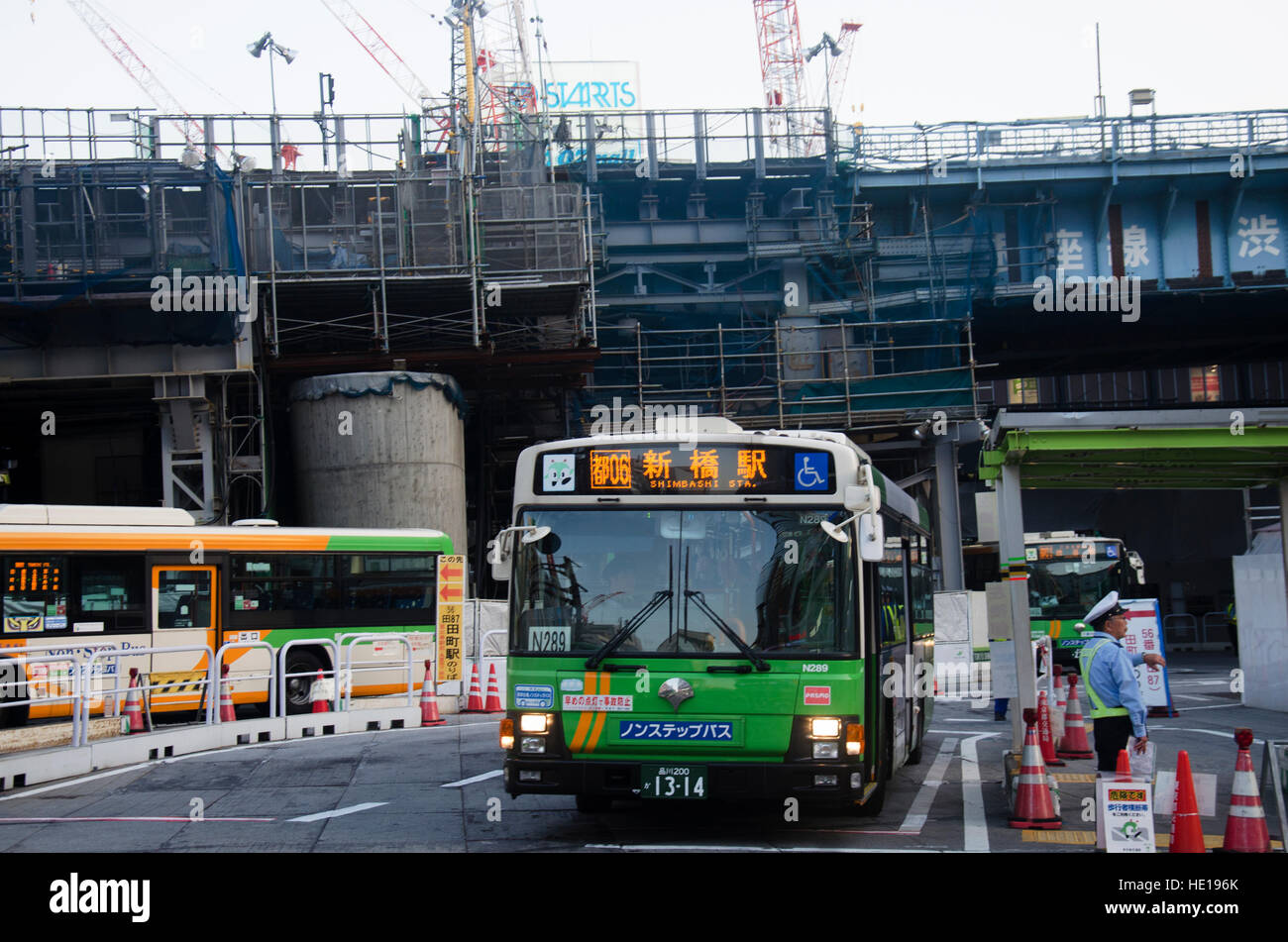 Cityscape and japanese people drive bus on traffic road and stop ...
