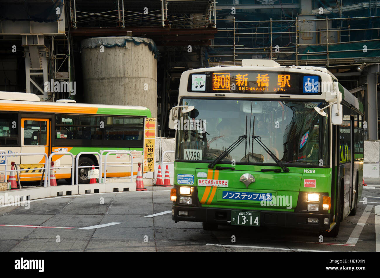 Cityscape and japanese people drive bus on traffic road and stop ...