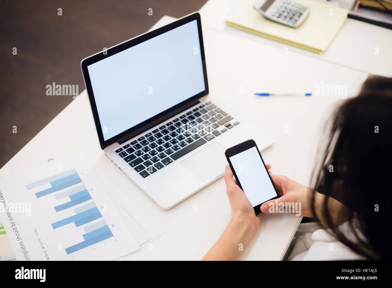 Woman's hands using mobile phone and laptop at the office Stock Photo ...