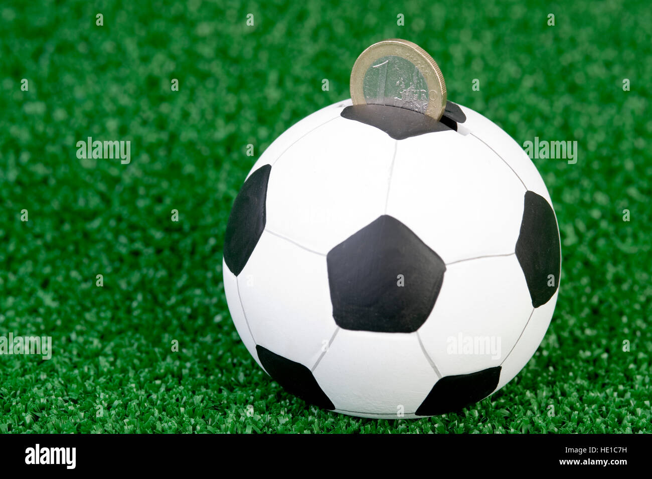 Symbolic picture of a football with a coin Stock Photo - Alamy
