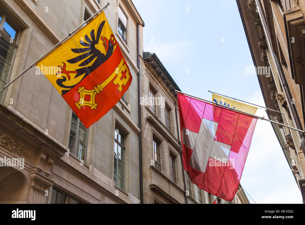 Geneva, Switzerland. Swiss National and City flags mounted on old house ...