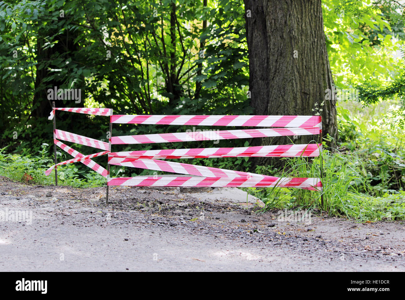 red white warning tape fencing is protects the open hatch Stock Photo ...