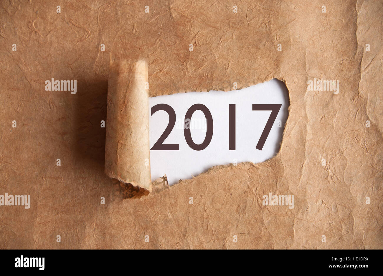 Torn piece of scroll revealing 2017 underneath Stock Photo - Alamy