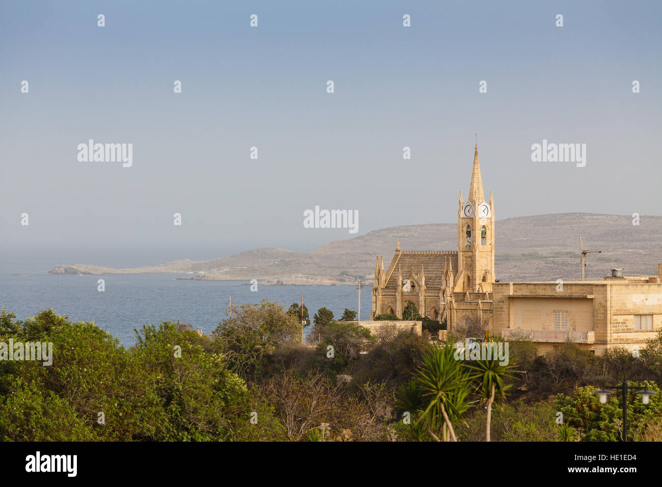 The Lourdes Chapel gothic church is dominating Ghajnsielem harbour ...