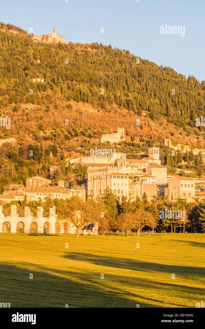 Roman Theatre ruins in Gubbio with the medieval town centre behind on ...
