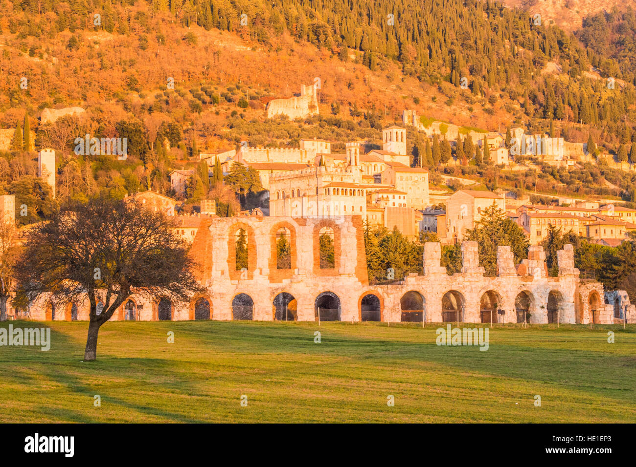 Roman Theatre ruins in Gubbio with the medieval town centre behind on ...
