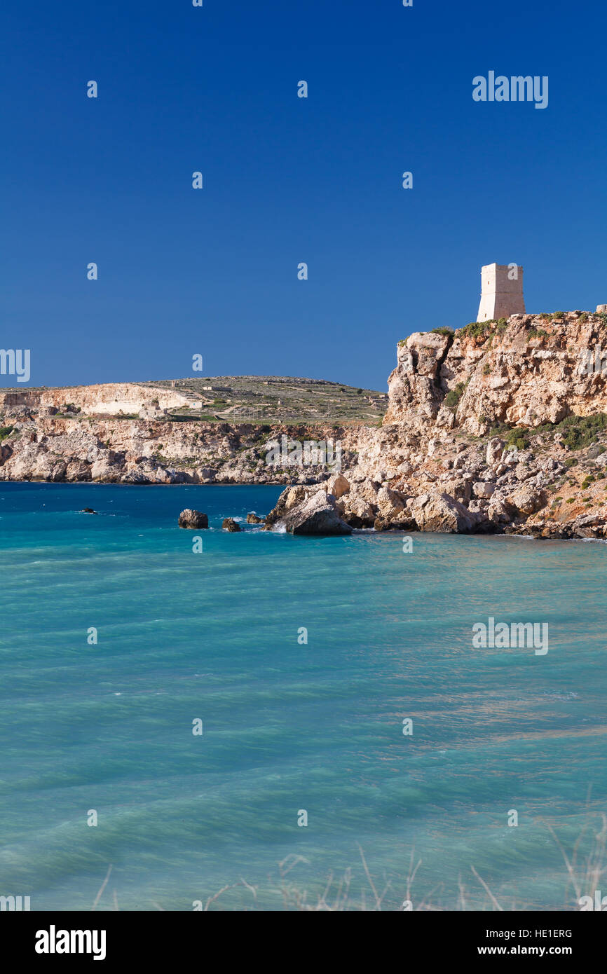 Maltese rocky seascape and Ghajn Tuffieha Tower, Riviera Bay, Malta ...