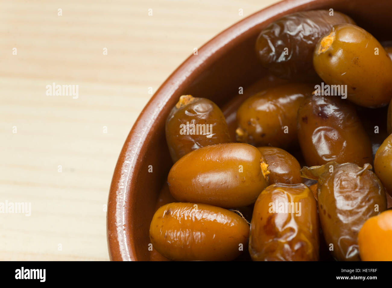 Dates in a clay pot. Artificial lighting with flaxes Stock Photo - Alamy