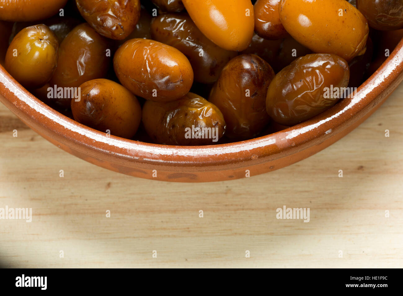 Dates in a clay pot. Artificial lighting with flaxes Stock Photo - Alamy
