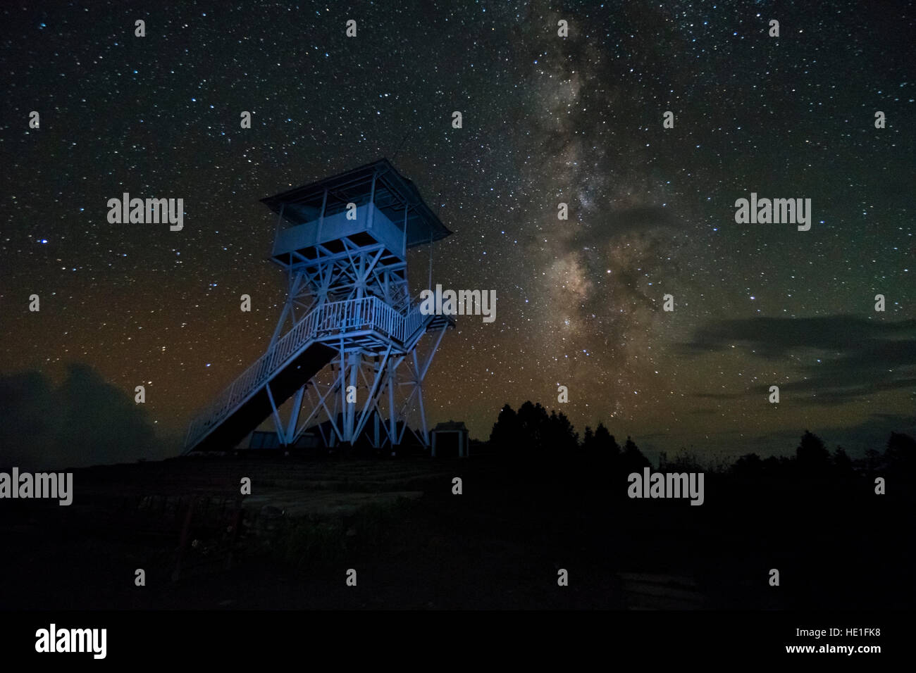 The illuminated watchtower of Poon Hill, seen at night with the milky ...