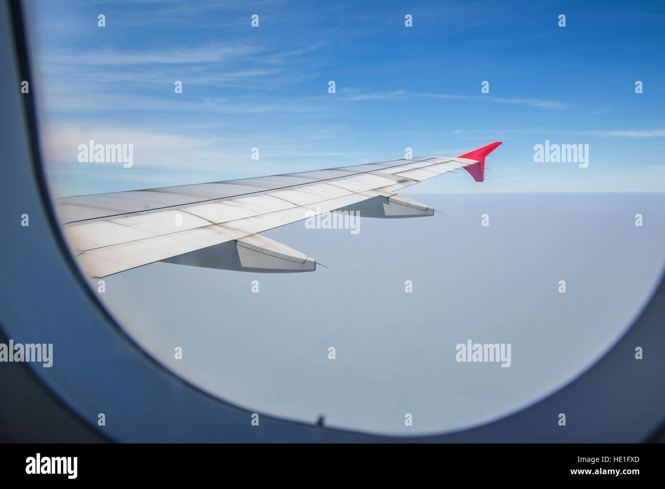 View through a window of an airplane wing aircraft flying above the ...