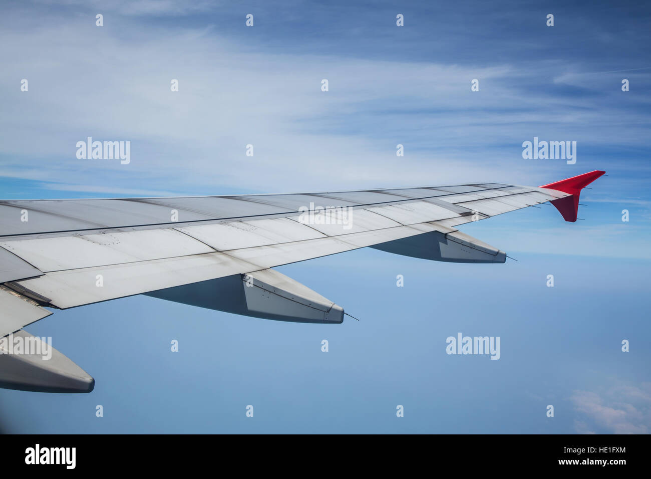 Right wing airplane flying above under blue sky Stock Photo - Alamy
