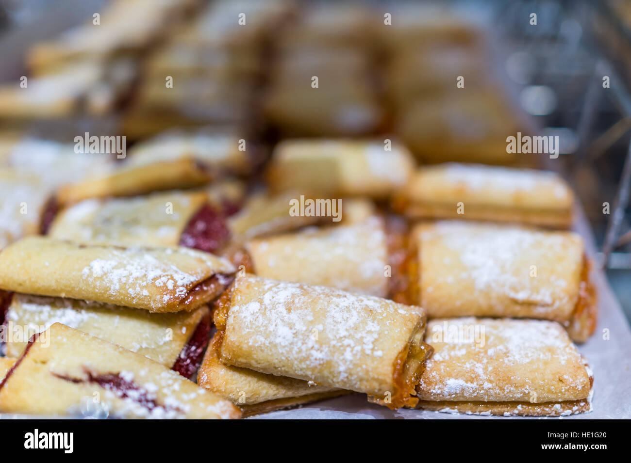 Closeup of many rectangular puff pastries filled with jam and topped ...