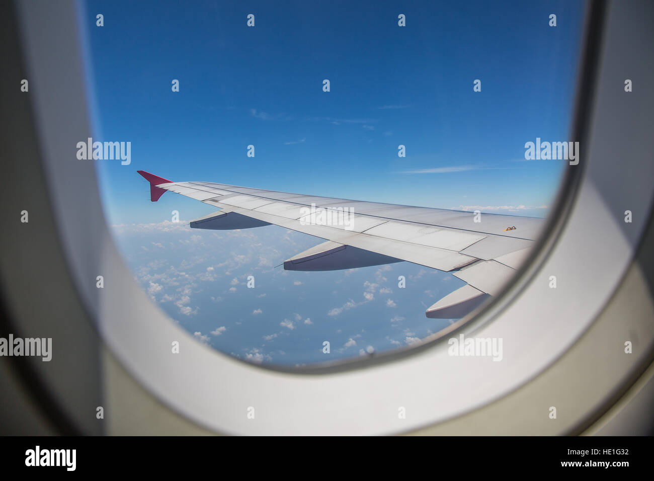 View through a window of an left airplane wing aircraft flying above ...