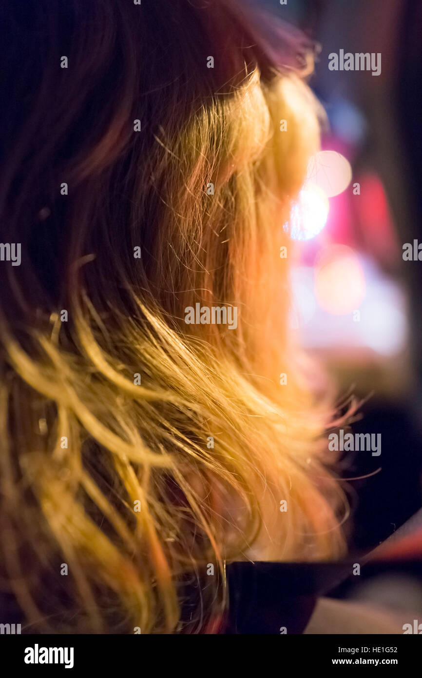 Blonde hair illuminated by red night traffic lights Stock Photo - Alamy