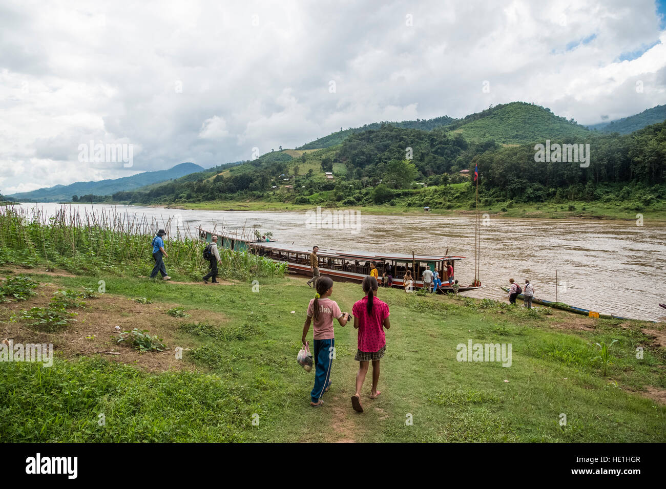 River scenery on the Mekong River Young children at a village on the ...